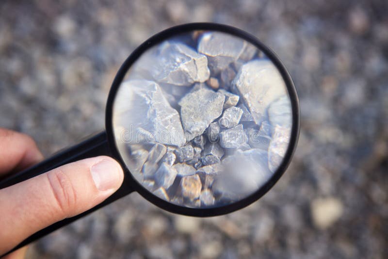 Hand Holding Magnifying Glass at Stones Stock Image - Image of ...