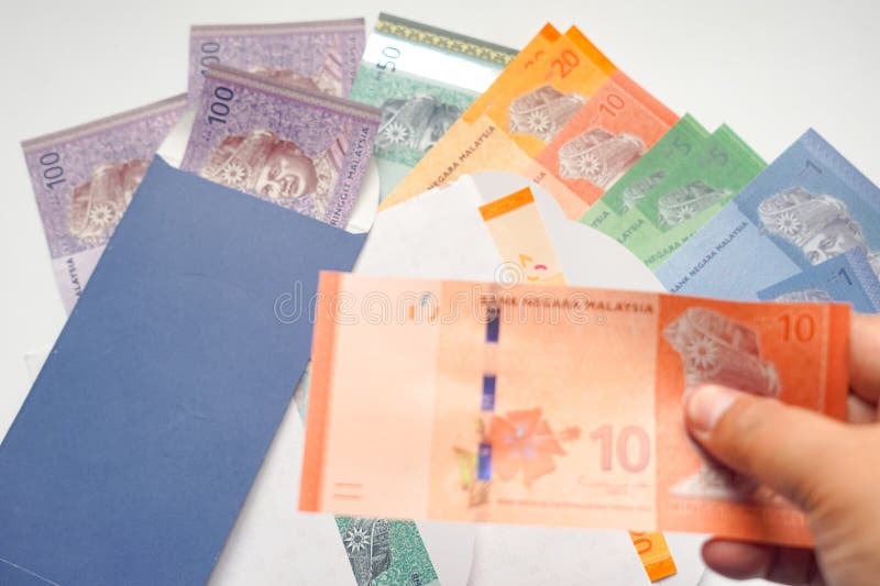 Hand Holding Malaysian Ringgit and Money Packet Stock Image - Image of ...