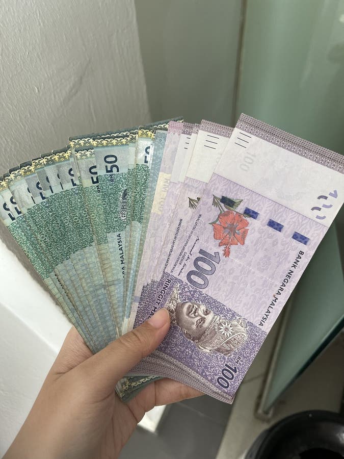Hand Holding Malaysian Ringgit Banknotes – RM50 and RM100 Stock Image ...