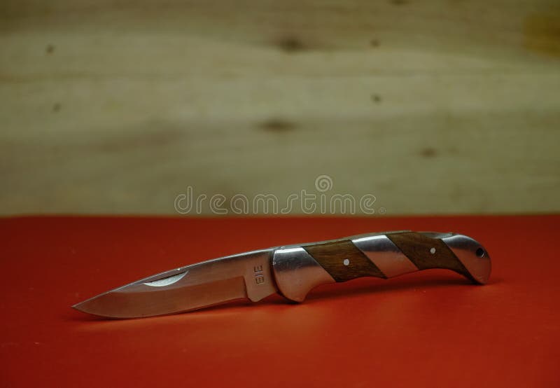 Hand Holding a Metal Knife that Stuck in the Wood Stock Photo - Image ...