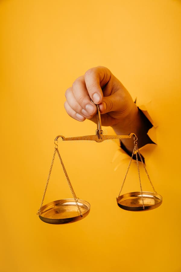 Hand Holding Metallic Scales from Yellow Torn Paper. Vertical Image ...