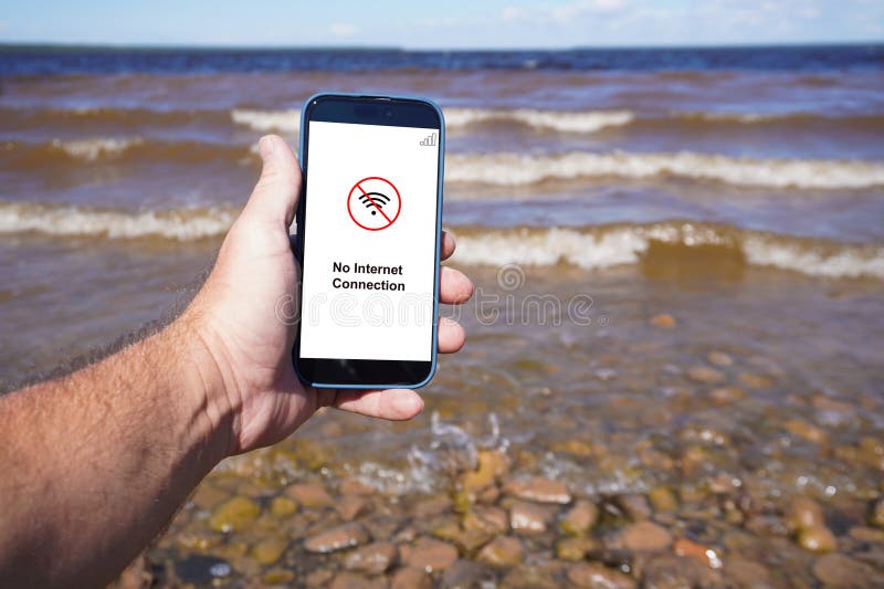 Man Holding Smartphone Showing No Internet Connection at the Beach ...