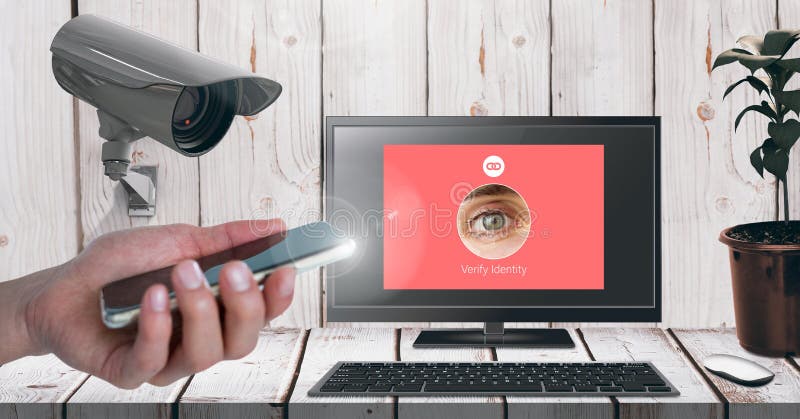 Hand Holding Mobile Phone with Security Camera Watching Laptop Identity ...