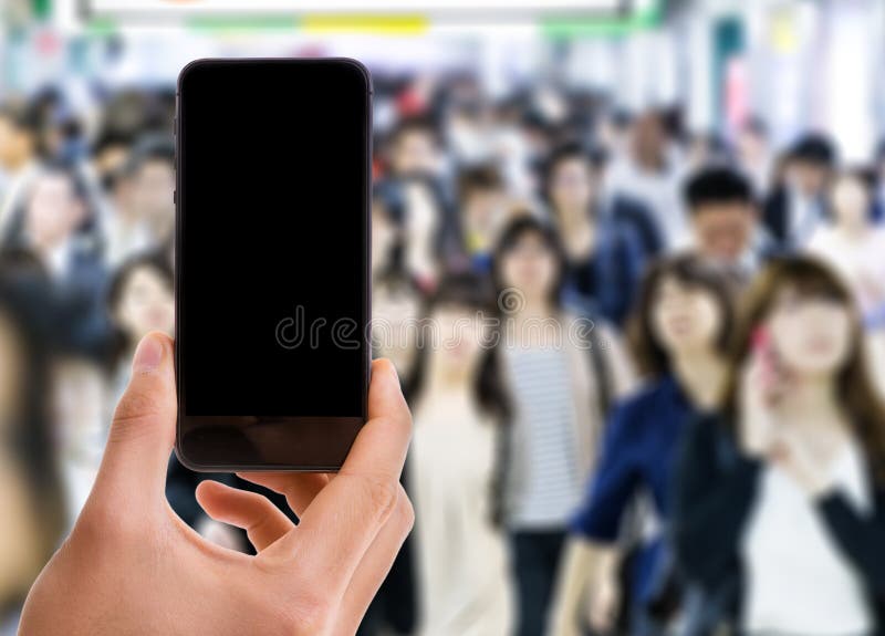 Hand Holding Mobile Smart Phone with Black Screen with a Crowd of ...
