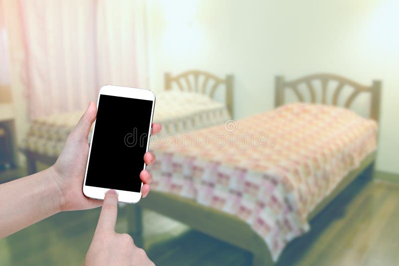 Hand Holding Mobile Smart Phone with Blur Bedroom Stock Image - Image ...
