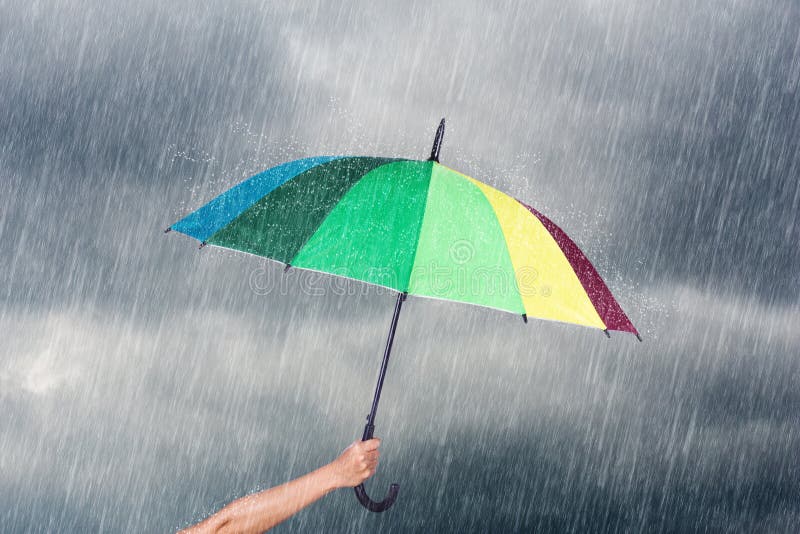 Hand Holding Multicolored Umbrella Under Dark Sky with Rain Stock Photo ...