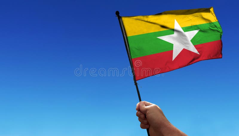 Hand Holding Myanmar Flag Waving Under Cloudy Sky. Stock Image - Image ...