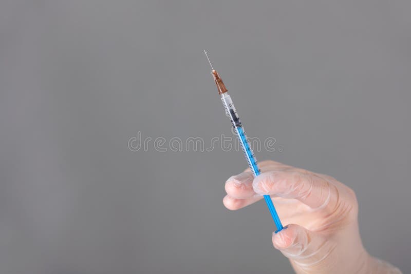 Hand Holding Needle Close Up Stock Photo - Image of injection, industry ...