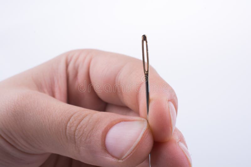 Hand holding a needle stock photo. Image of join, flat - 145709658