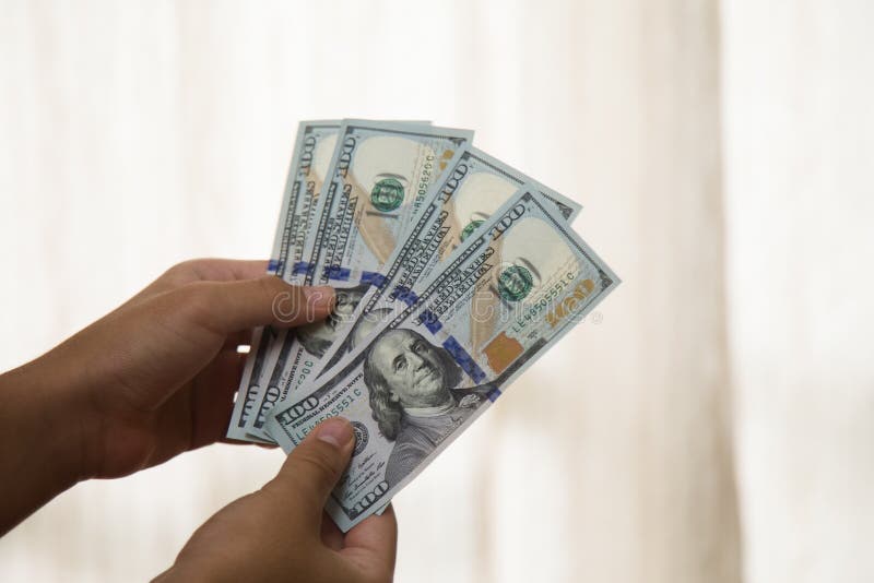 Hand Holding Notes of One Hundred Dollars. Stock Image - Image of large ...