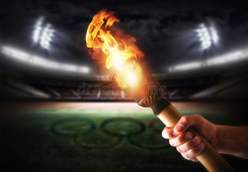 Hand Holding Olympic Torch with Stadium Behind at Night Stock Image ...