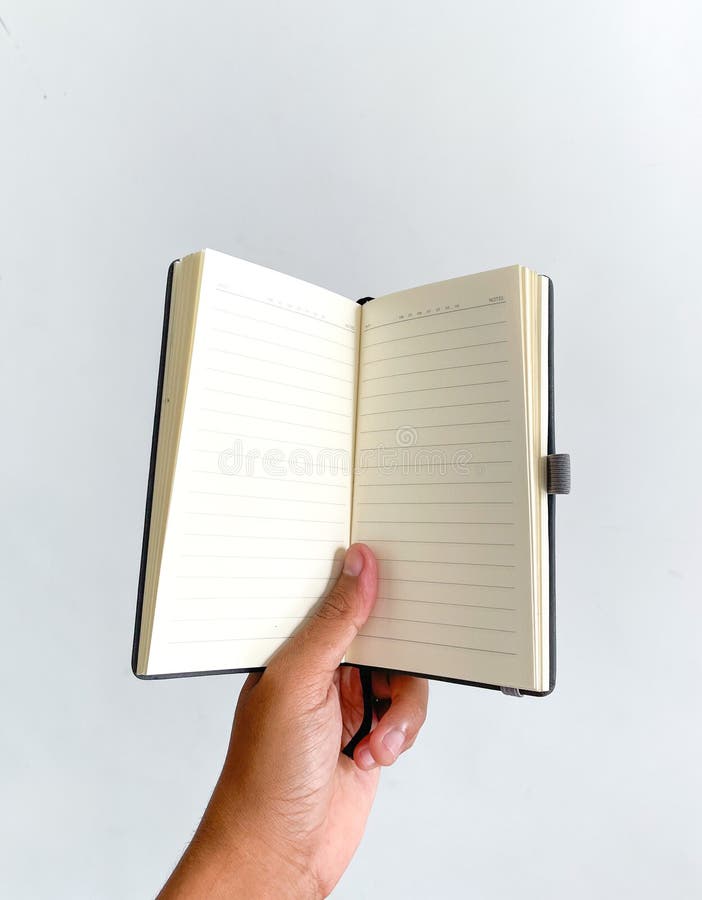 A Hand Holding an Opened Textbook. Paper Copy Space in an Opened ...