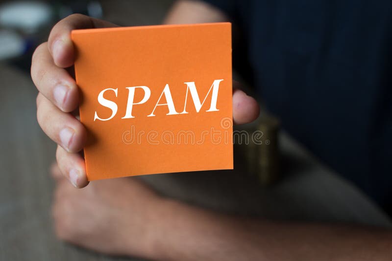 Hand Holding Orange Paper with the Word Spam, Technology Concept Stock ...