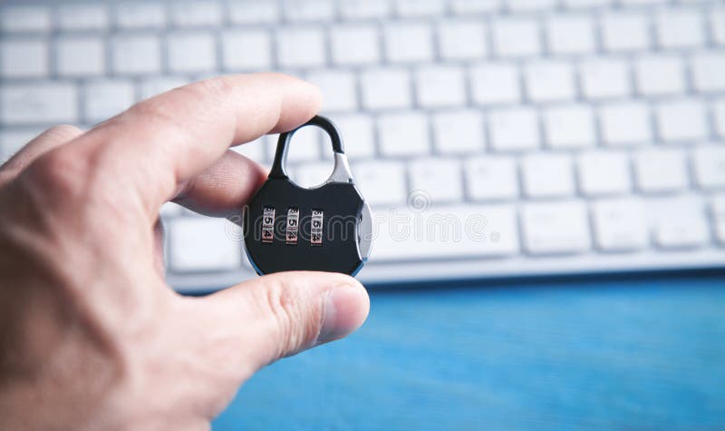Hand Holding Padlock Over Computer Keyboard. Internet and Computer ...