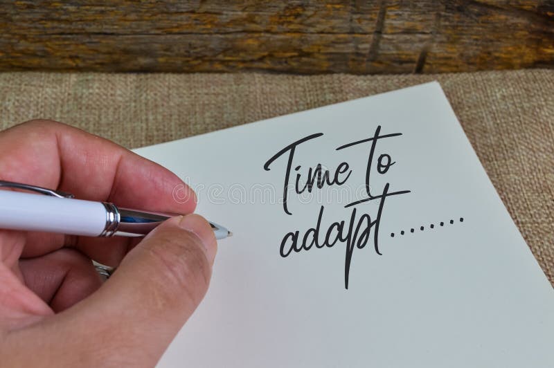 Hand Holding Pen and Write TIME TO ADAPT Stock Image - Image of normal ...