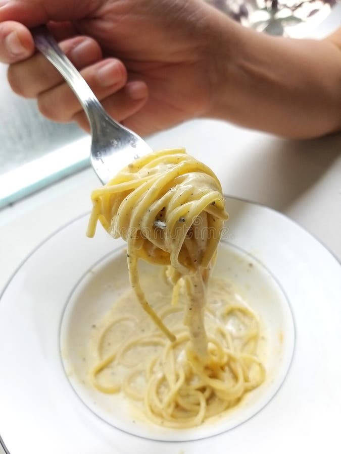 Hand Holding Spaghetti on Fork Stock Photo - Image of farinaceous ...