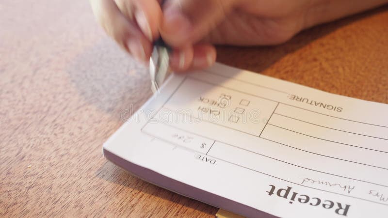 Detailed CloseUp View of a Hand Writing on a Receipt with a Pen Stock ...