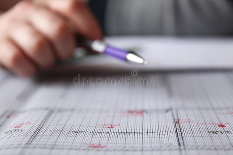 Hand Holding a Pen, Drawing on a Blueprint or Construction Plans ...