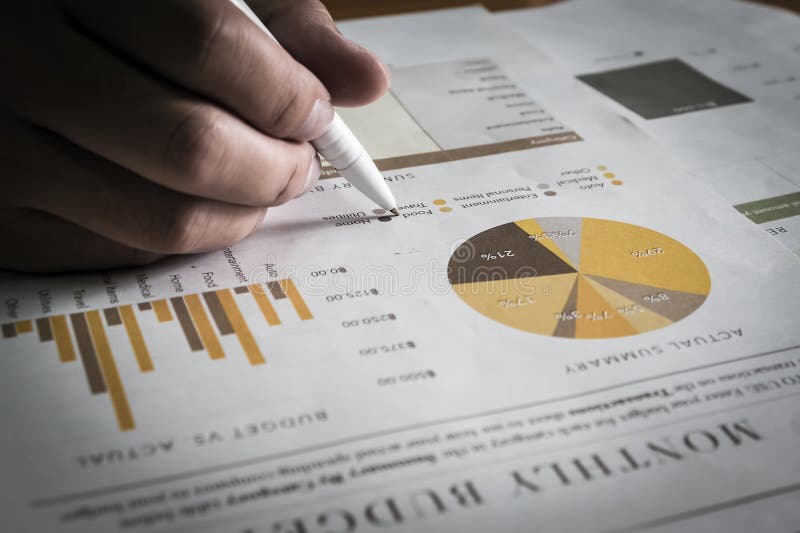Hand Holding Pen Pointing Stock Market Document for Analysis Document ...