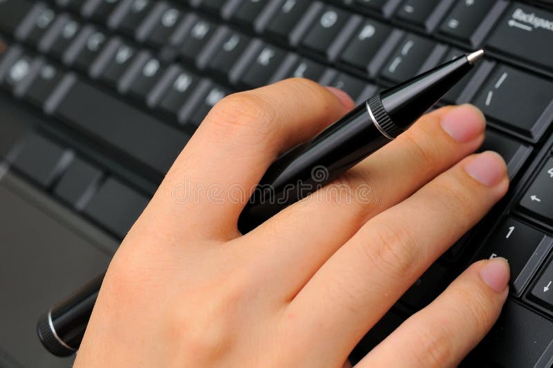 Hand Holding Pen and Typing Stock Photo - Image of finger, type: 20326516