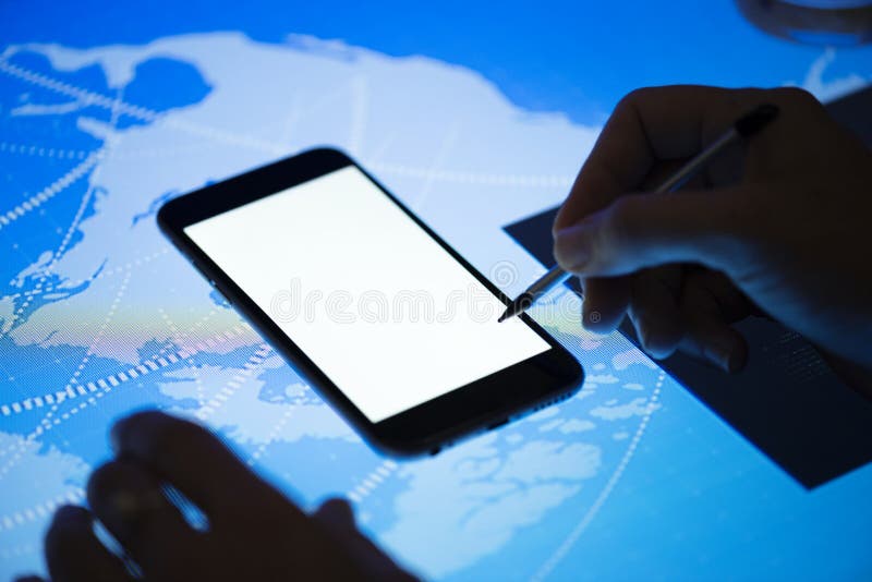 Hand Holding a Pen Writing Down on a Smart Phone Screen Stock Photo ...