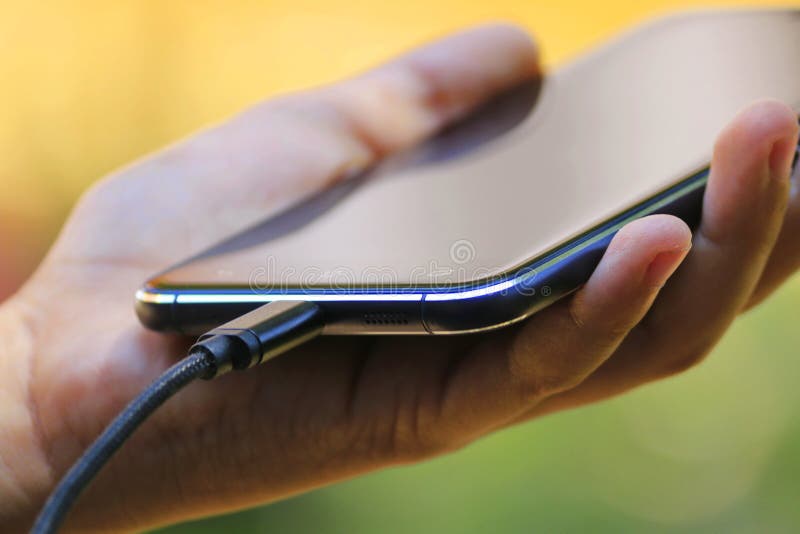 Hand Holding the Phone with the Charging Cable Stock Image - Image of ...