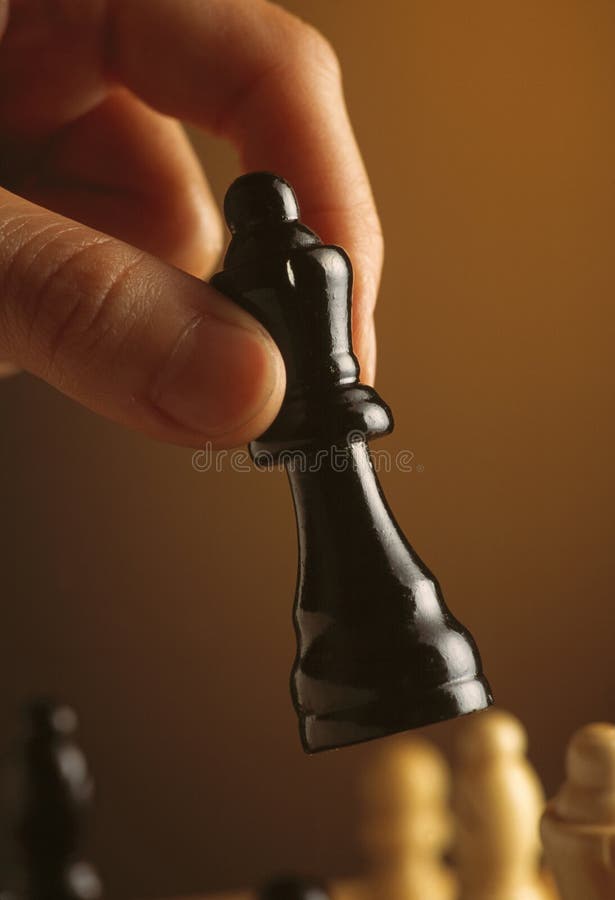 Hand Holding a Piece of Black Chess Stock Image - Image of hand ...
