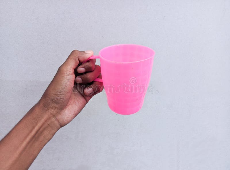 Hand Holding Pink Plastic Cup on White Background. Stock Image - Image ...