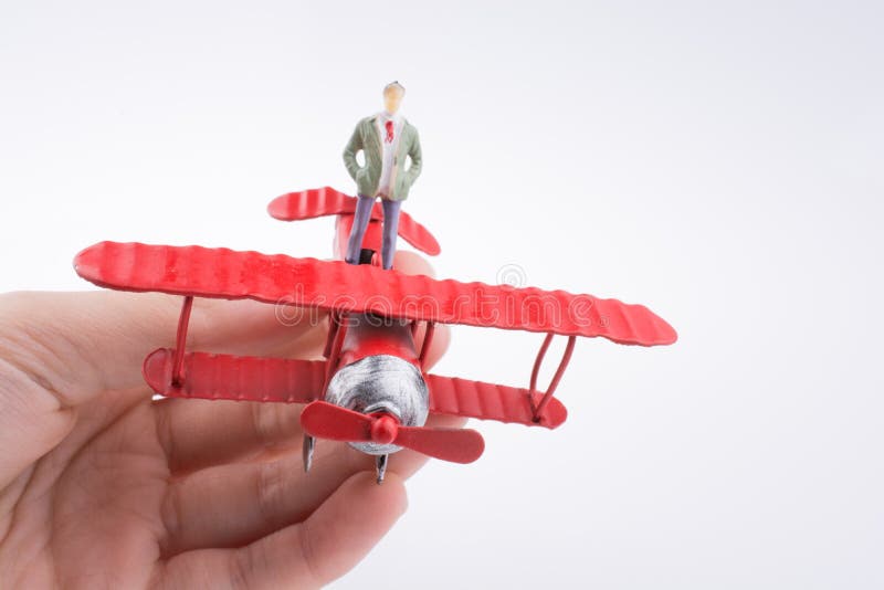 Hand Holding Plane with a Figure on it Stock Image - Image of figures ...