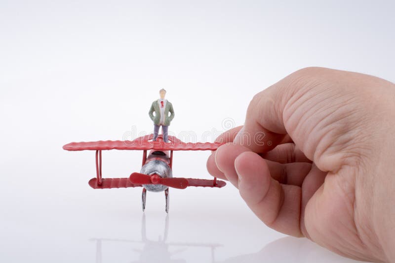 Hand Holding Plane with a Figure on it Stock Image - Image of flat ...