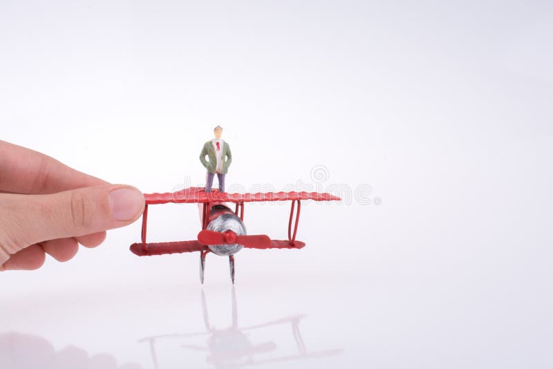 Hand Holding Plane with a Figure on it Stock Image - Image of isolated ...
