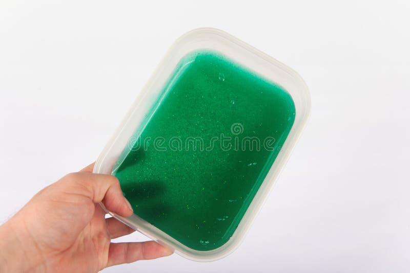Hand Holding Plastic Box with Green Slime Stock Photo - Image of hand ...