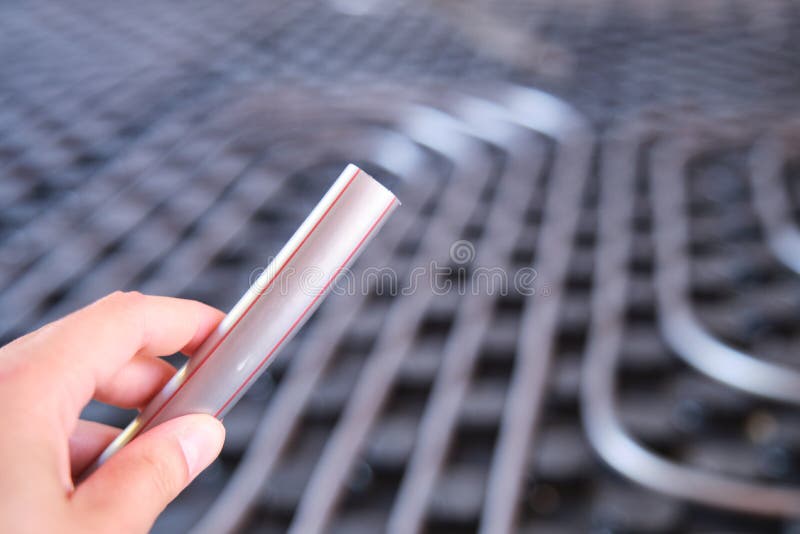 Hand Holding a Polyethylene Pipe Used for Underfloor Heating and ...