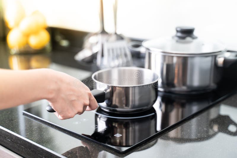 Hand Holding a Pot in the Kitchen. Stock Image - Image of kitchenware ...
