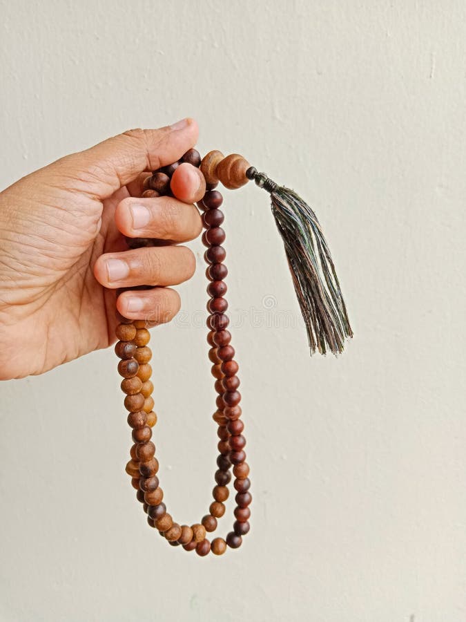 The Hand Holding the Prayer Beads is Light Brown Stock Photo - Image of ...