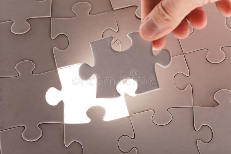 Hand holding puzzle piece stock image. Image of hand - 26375053