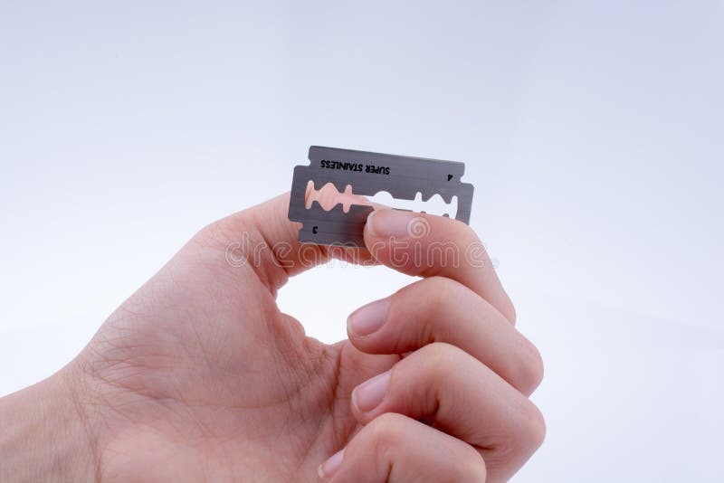 Hand holding a razor blade stock photo. Image of stainless - 75542052