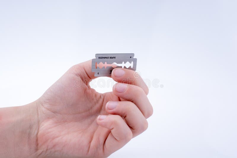 Hand holding a razor blade stock image. Image of sharp - 122910499