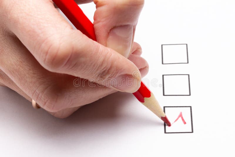 Hand Holding a Red Pencil Makes a Choice in the Voting Questionnaire ...