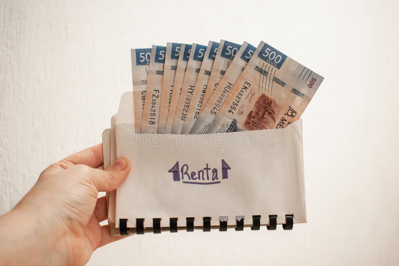 Hand Holding Rent Payment Envelope with Bills Inside. Stock Image ...