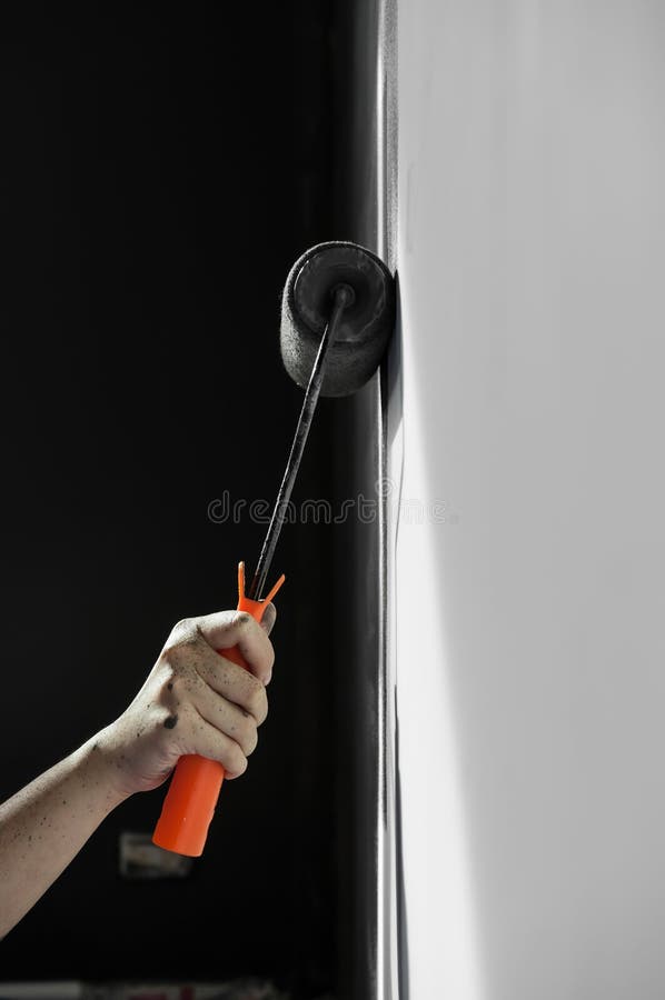 Hand Holding Roller Paint Applying Grey Paint on White Wall. Stock ...