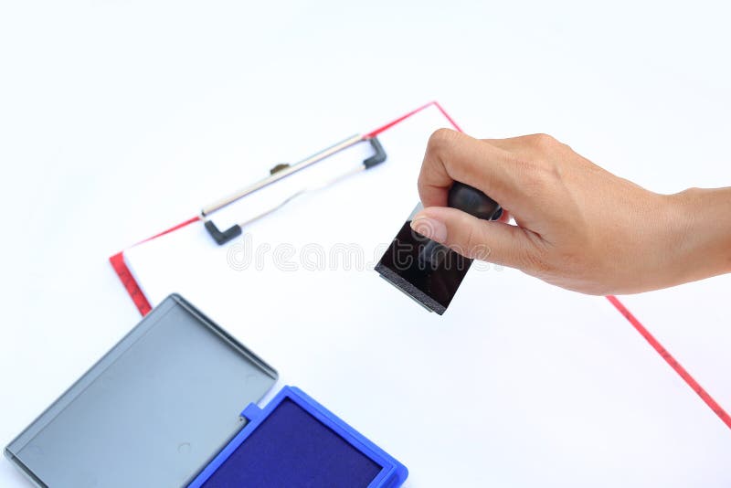 Hand Holding Rubber Stamper with Blue Ink Padbox on White Paper Stock ...