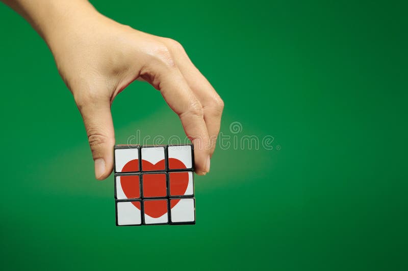 A Hand Holding a Rubik S Cube with a Heart on it Stock Photo - Image of ...