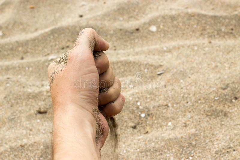 Sand Running Out from Hand Holding it at the Beach Stock Image - Image ...
