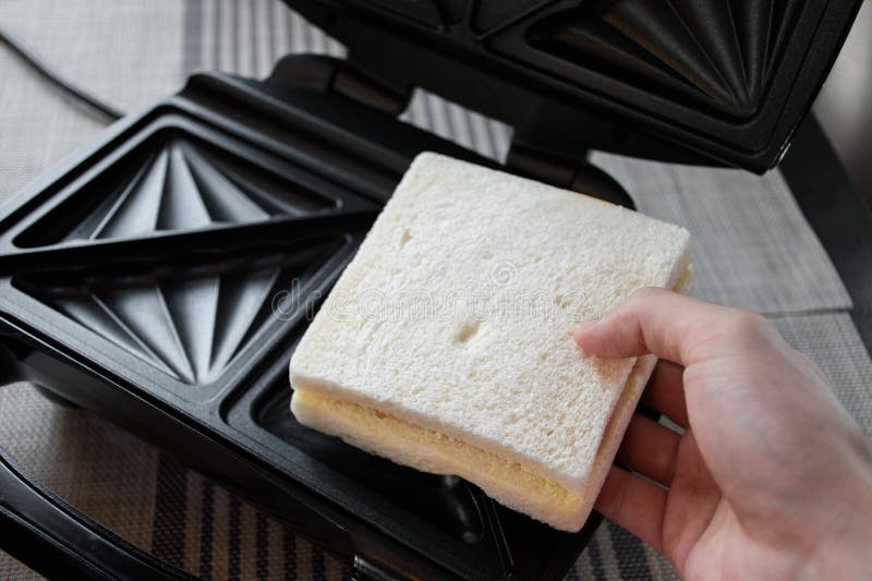 Hand Holding Sandwich Bread into a Toaster for Making Hot Toast ...