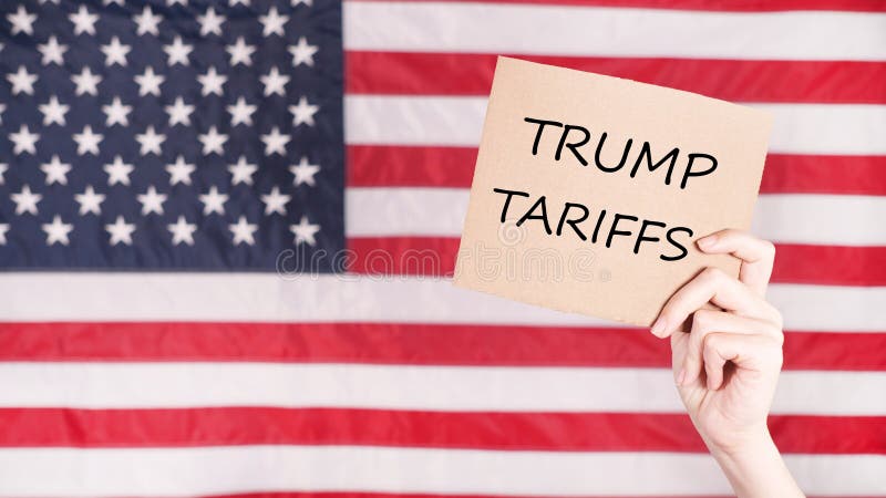 Hand Holding Sign with Text Trump Tariffs Against American Flag on ...