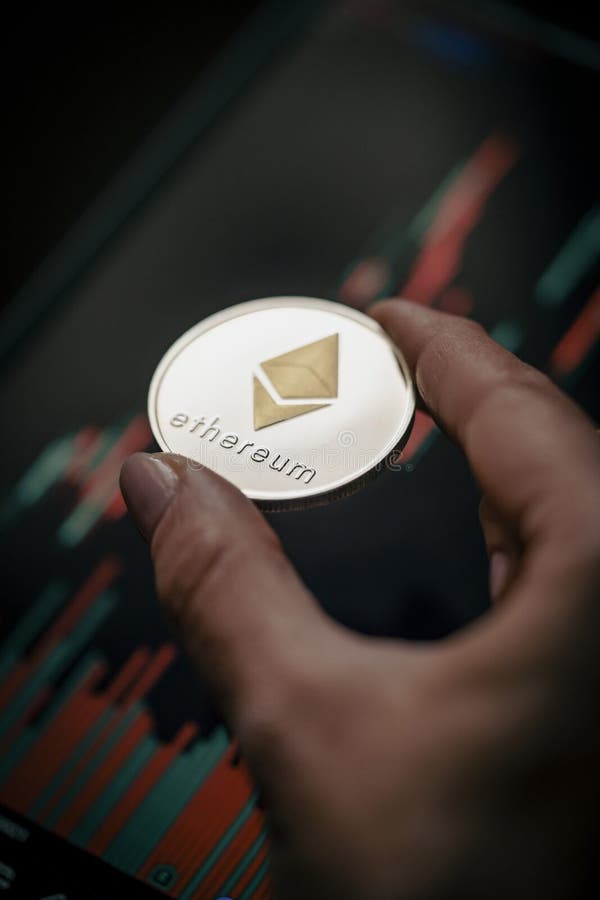 Hand Holding Silver Ethereum Coin with Candle Stick Graph Chart and ...