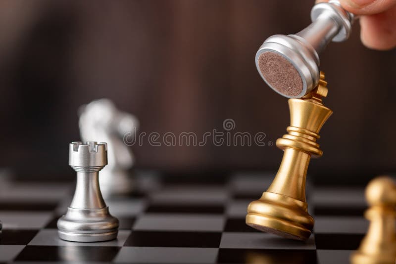 Hand Holding Silver King Attack Gold Leader in Game Stock Image - Image ...