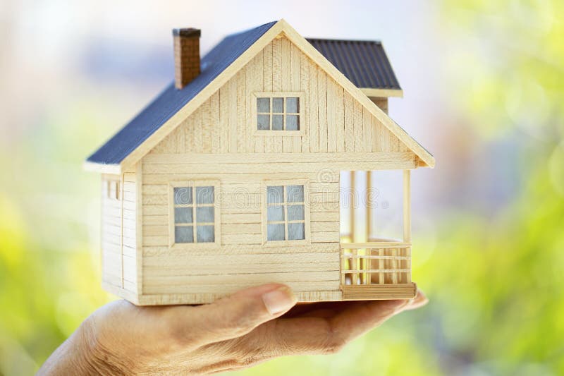 A Hand Holding a Small Model House. Home Protection Concept Stock Image ...