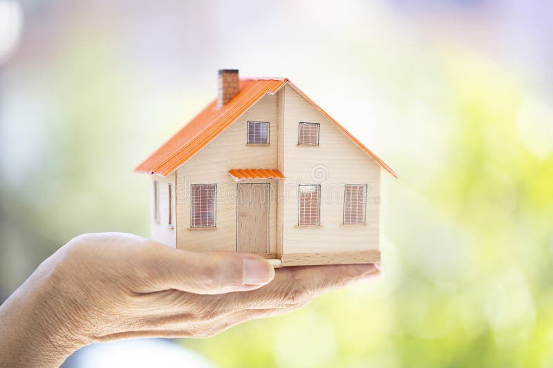 A Hand Holding a Small Model House. Home Protection Concept Stock Image ...